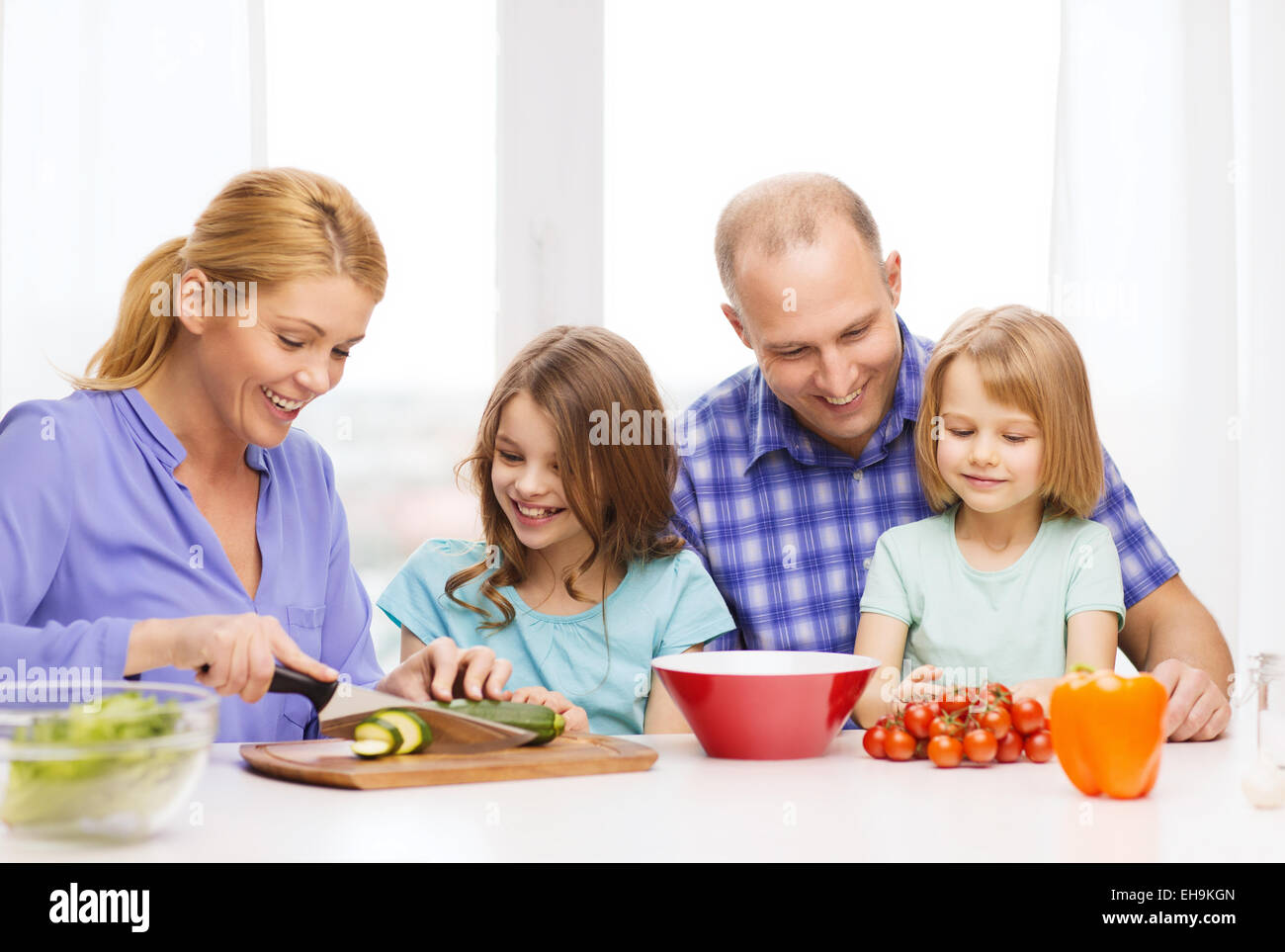 happy family with two kids making dinner at home Stock Photo - Alamy