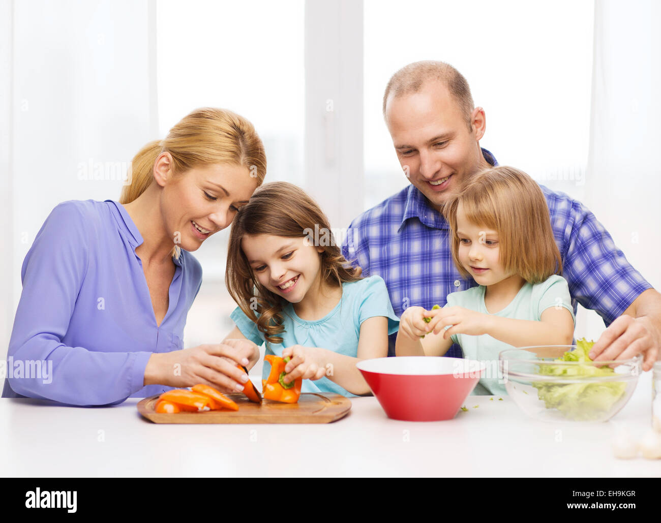 happy family with two kids making dinner at home Stock Photo - Alamy