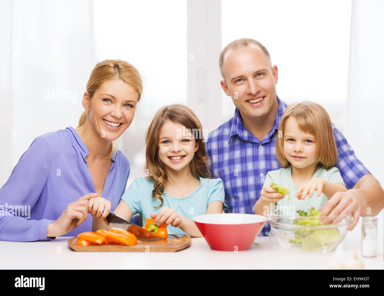 happy family with two kids making dinner at home Stock Photo - Alamy