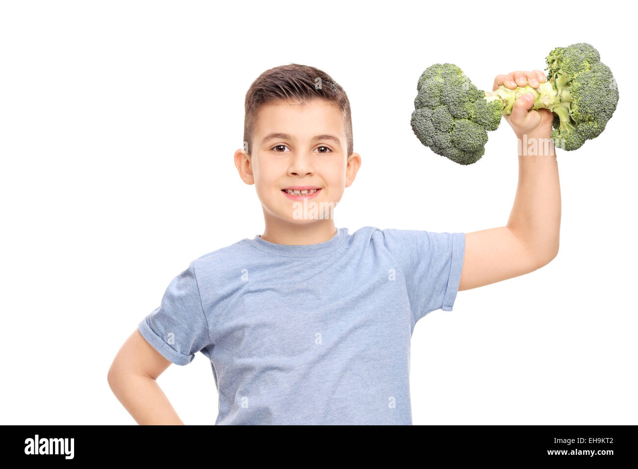 Little boy exercising with a broccoli dumbbell isolated on white ...