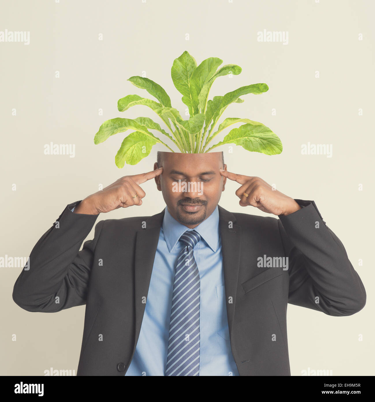 Plant growing up from Indian businessman head, eco business concept ...