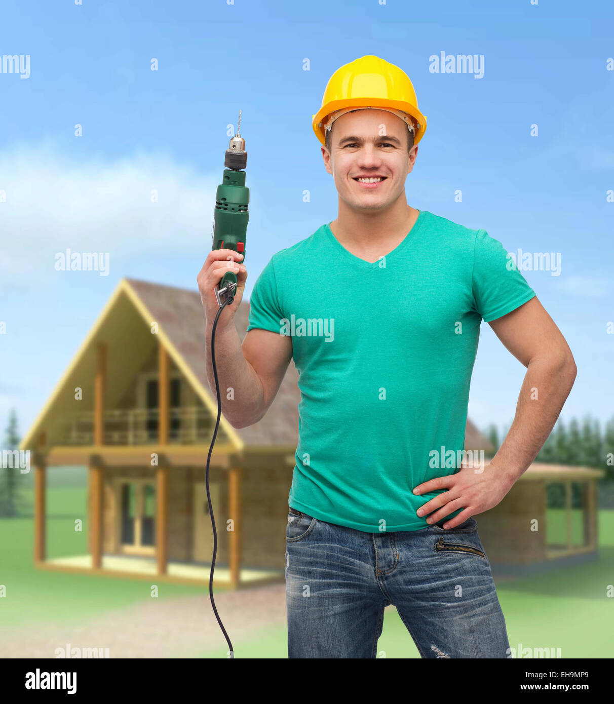 smiling manual worker in helmet with drill machine Stock Photo - Alamy