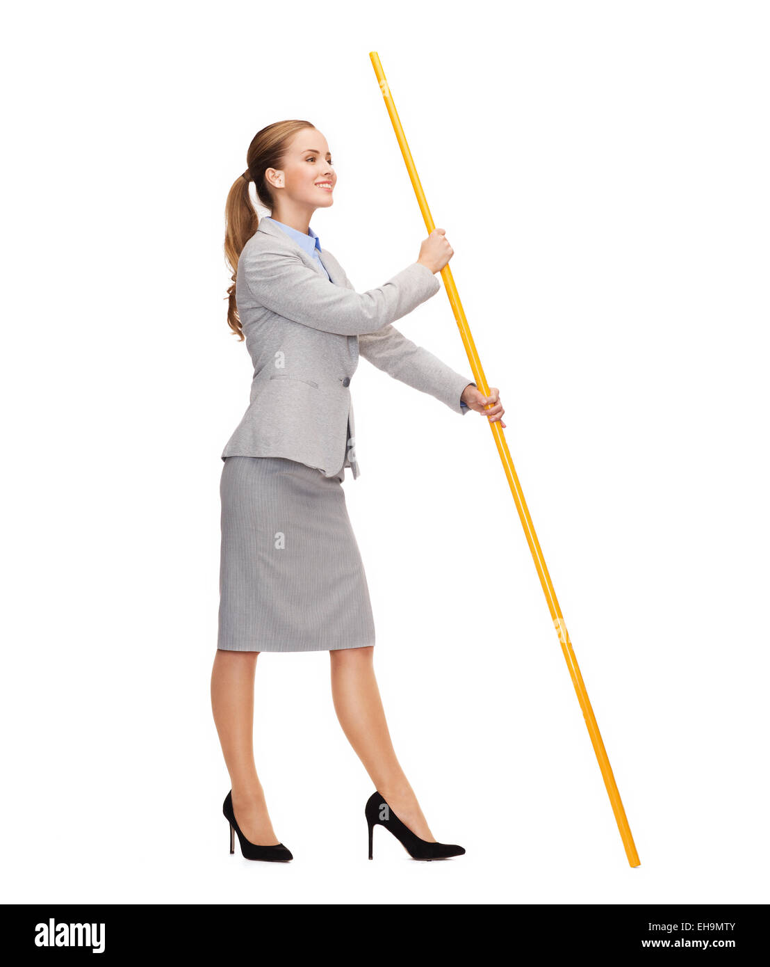 smiling woman holding flagpole with imaginary flag Stock Photo - Alamy