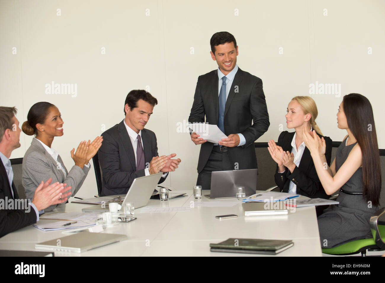 Executive receiving applause from colleagues during presentation Stock ...