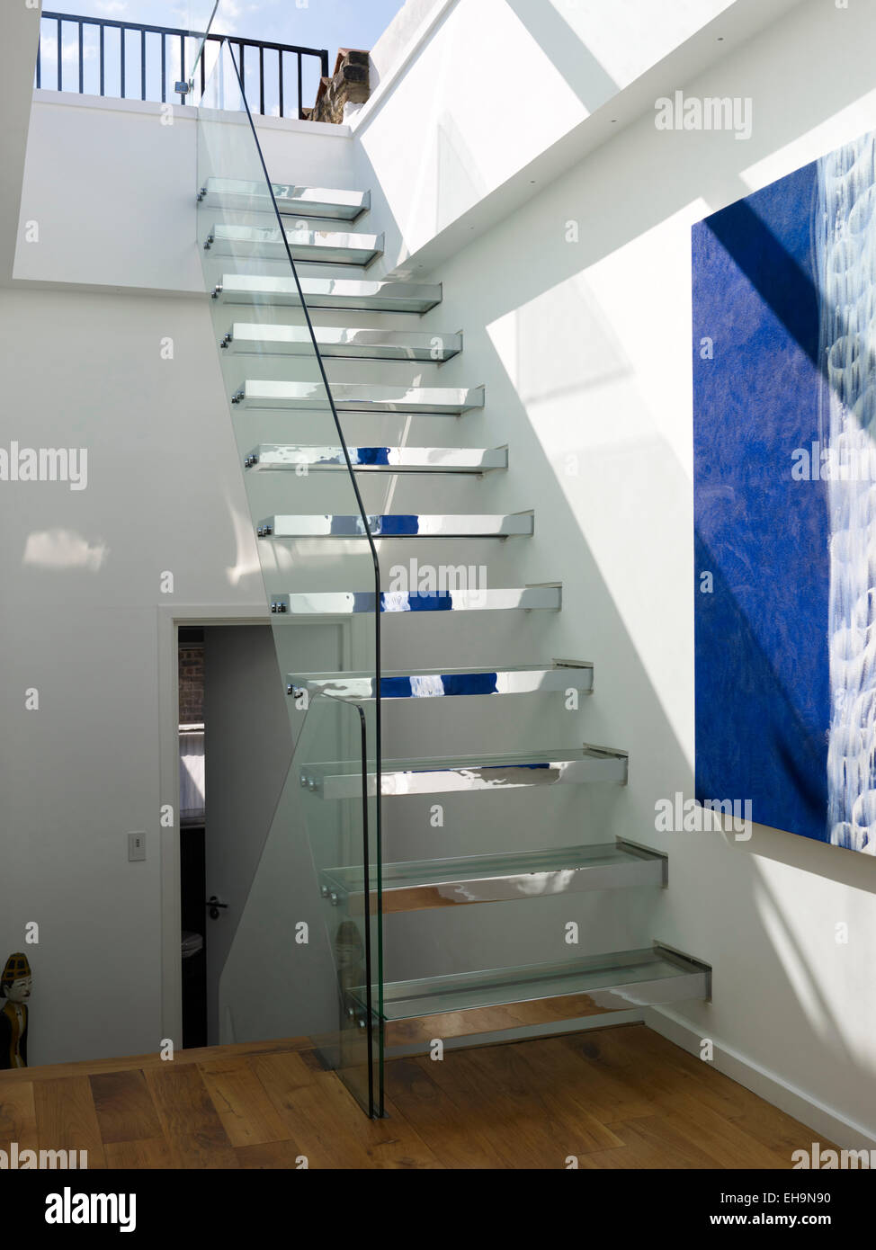 Metallic edged staircase with glass hand rail looking up to rooftop ... Metallic edged staircase with glass hand rail looking up to rooftop ...