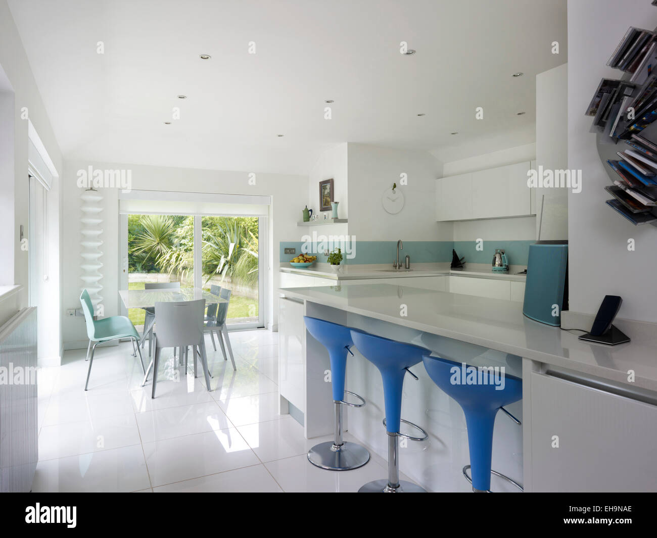 Breakfast bar with blue stools with entertainment centre in modern ...