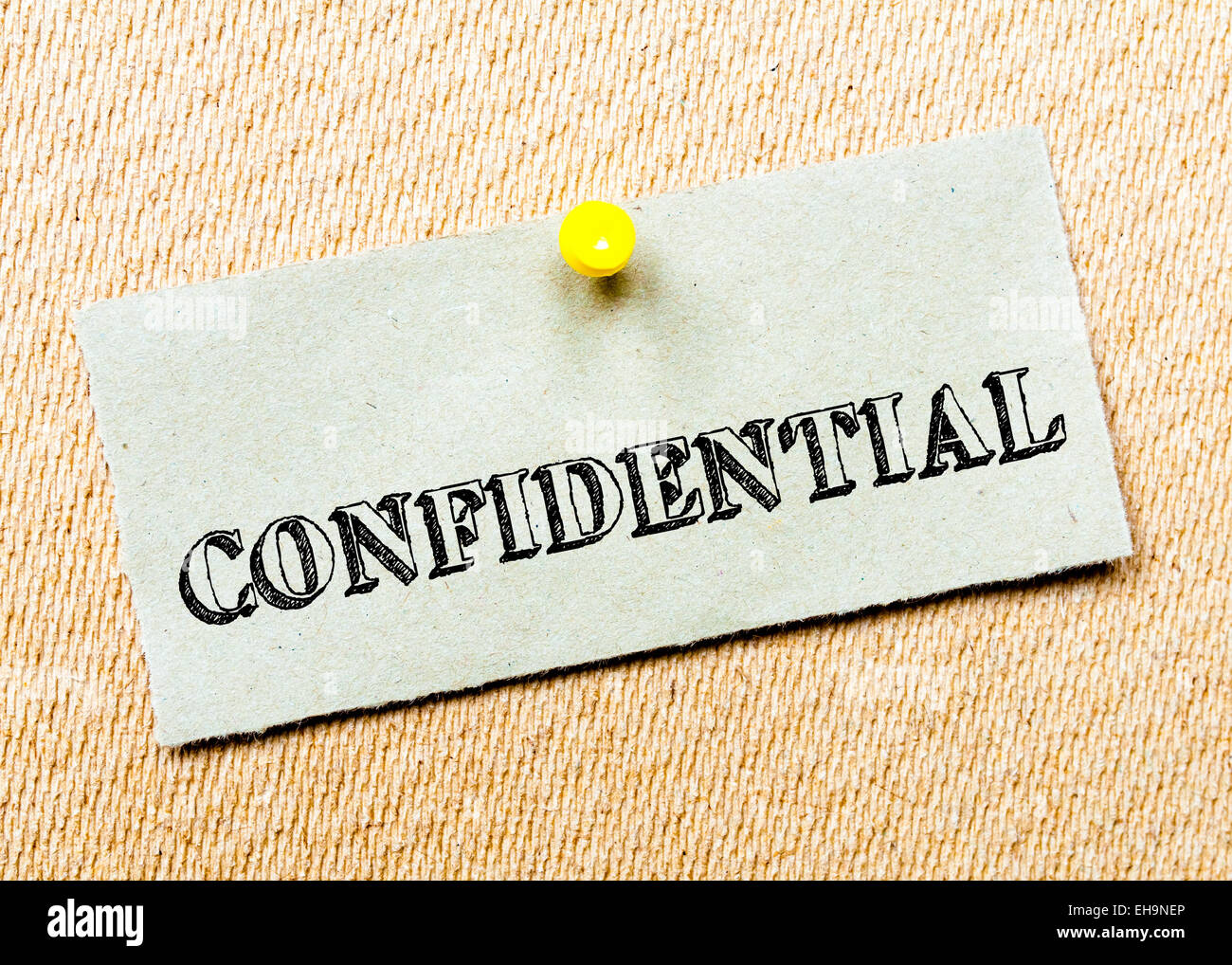Recycled paper note pinned on cork board.Confidential Message. Concept ...