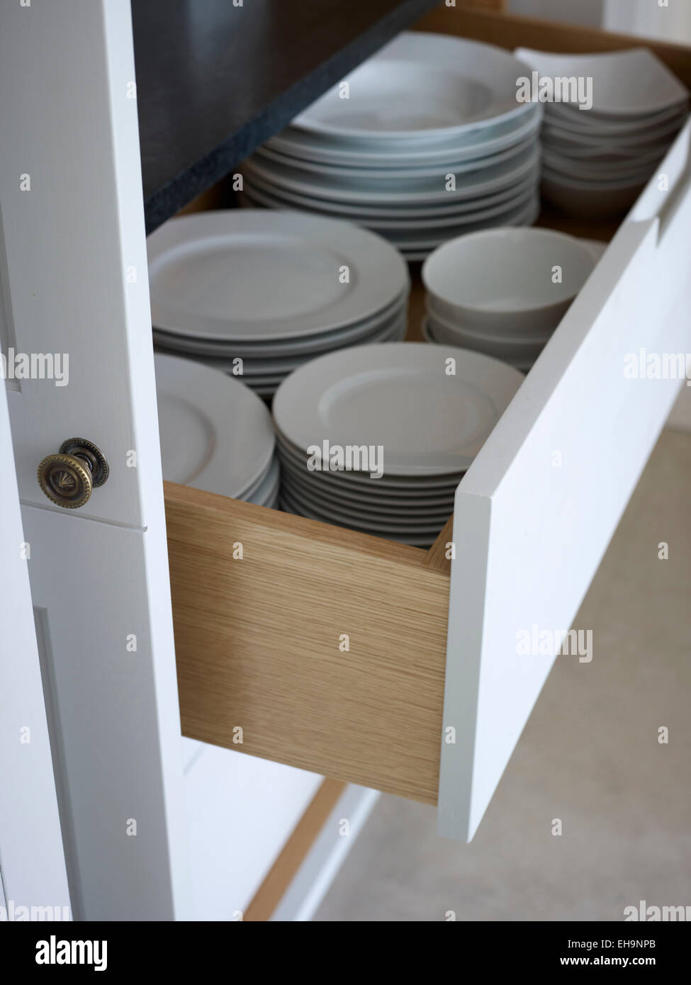 Open drawer detail with crockery in kitchen of Edenhurst Road home, UK ...
