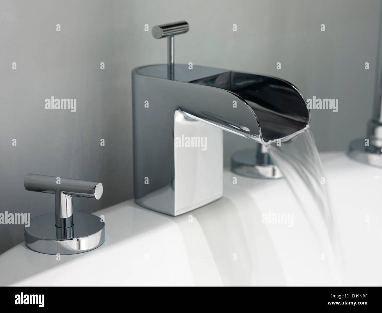 Modern metallic tap running into basin in bathroom of Fernhurst Road ...