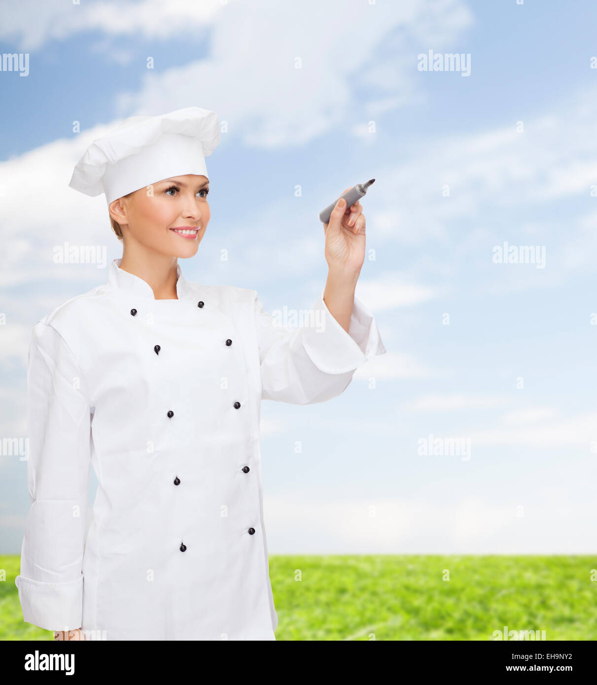 smiling female chef writing something on air Stock Photo - Alamy