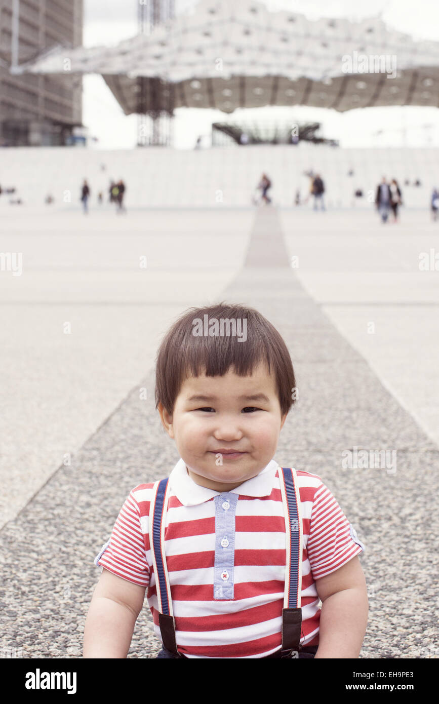 Baby boy in city square, portrait Stock Photo - Alamy