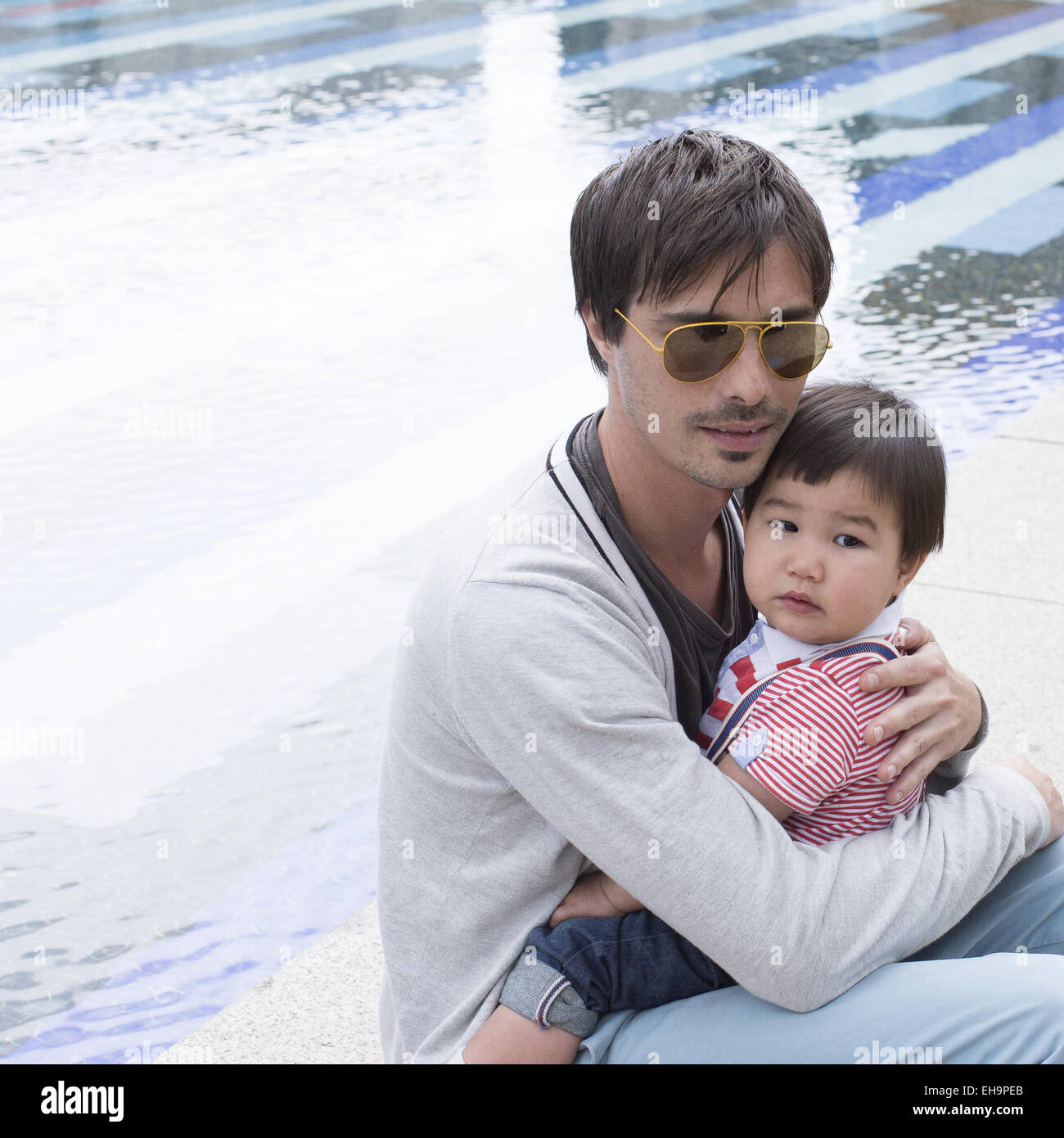 Child sitting in fathers lap hi-res stock photography and images - Alamy