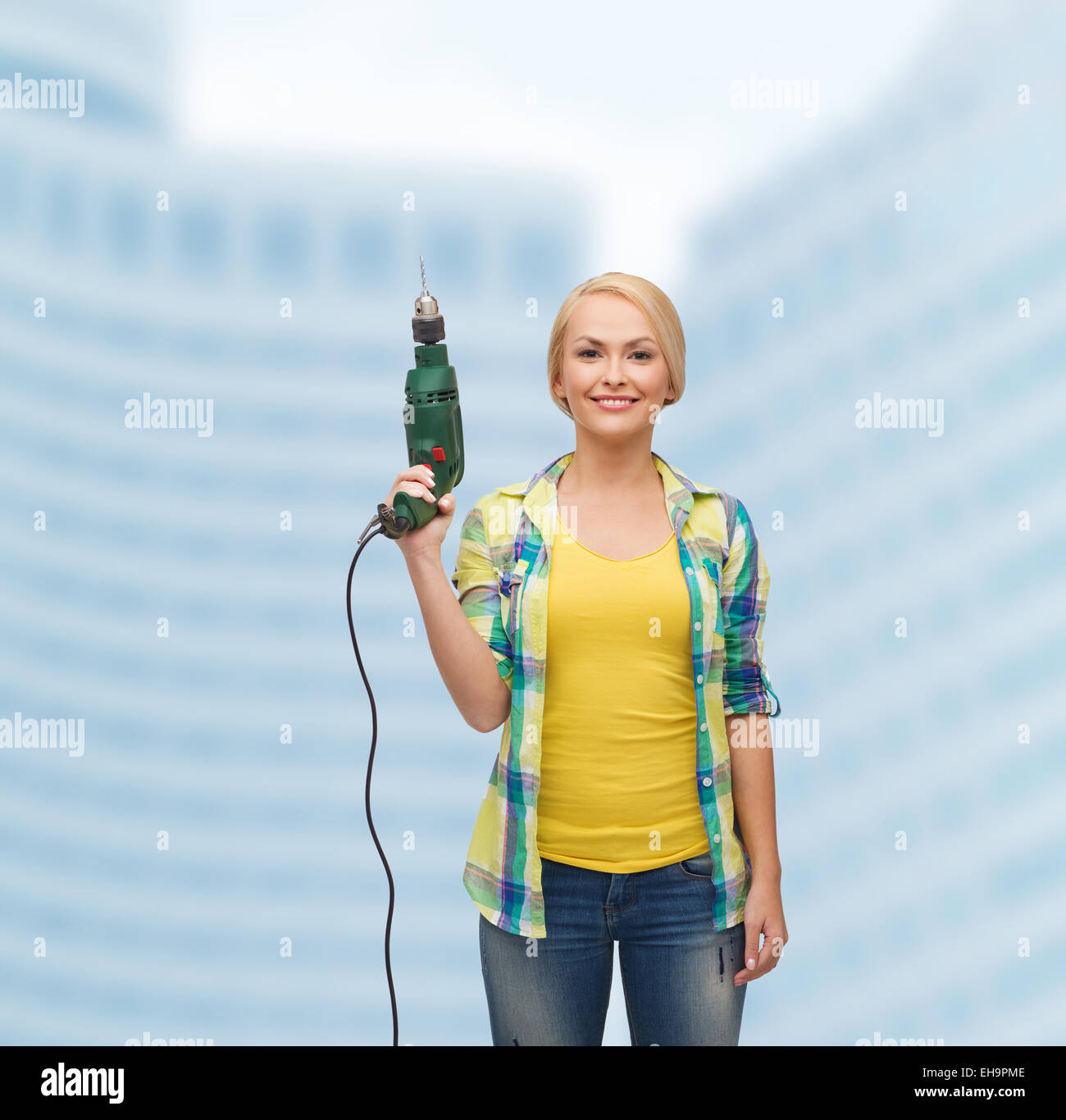 smiling woman with drill machine Stock Photo - Alamy