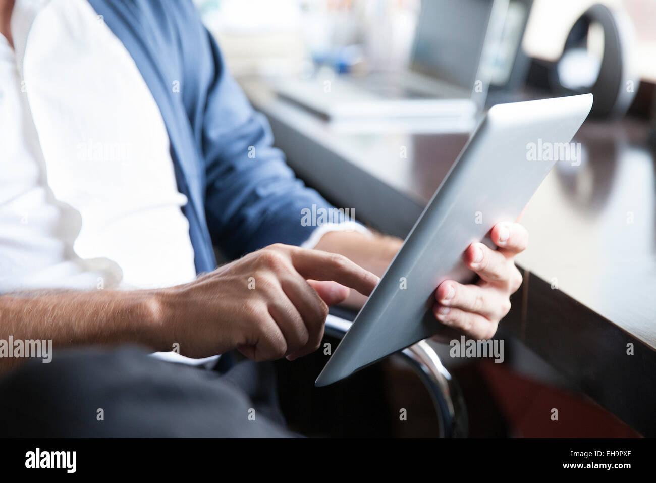 Mid adult man working with digital pad hi-res stock photography and ...