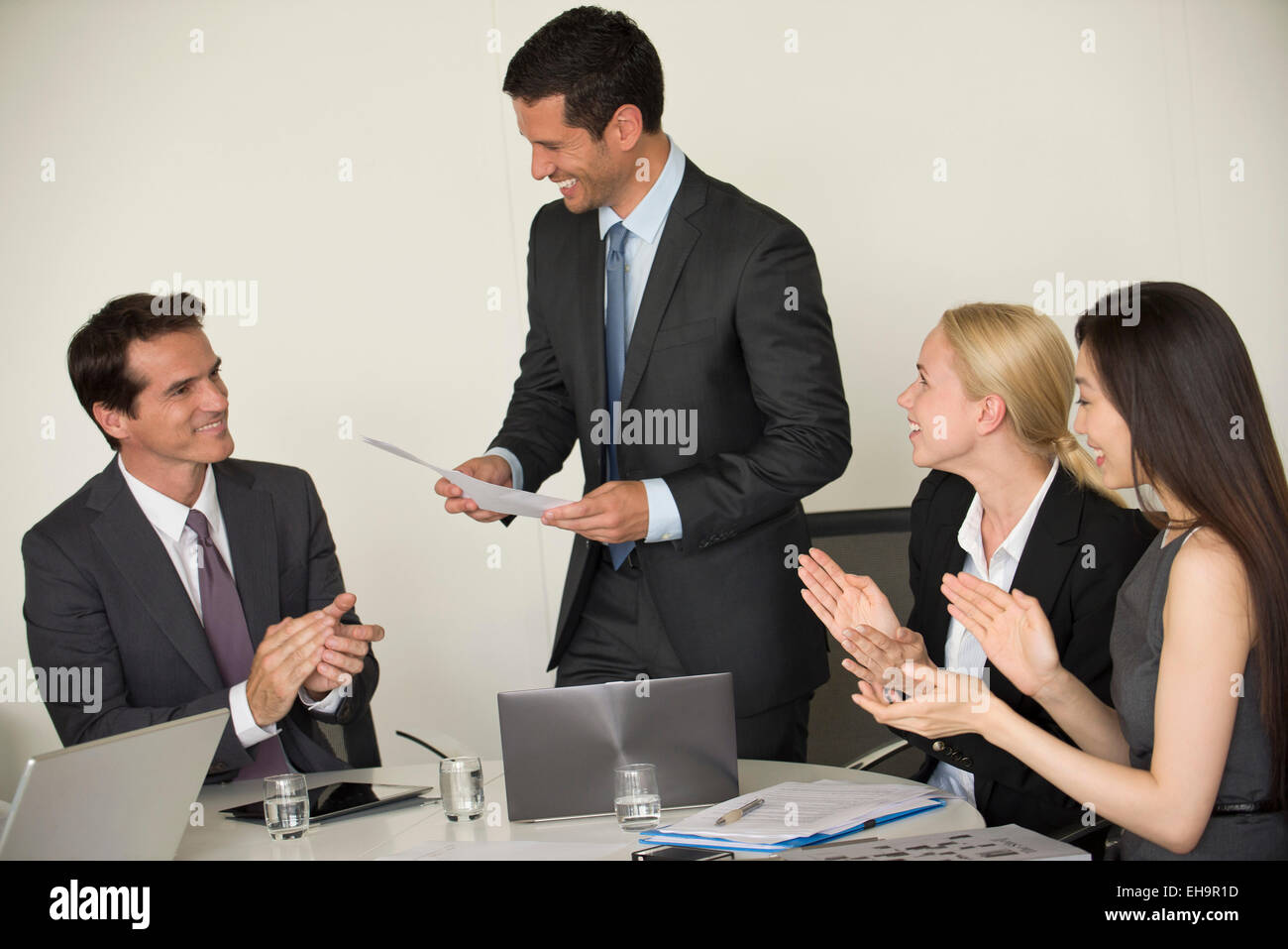 Executive receiving applause from colleagues during presentation Stock ...