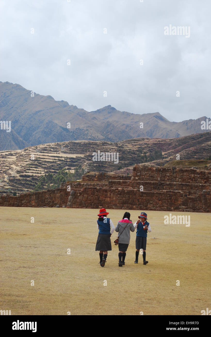 School children exploring the historical Inca ruins in Chinchero, Peru ...