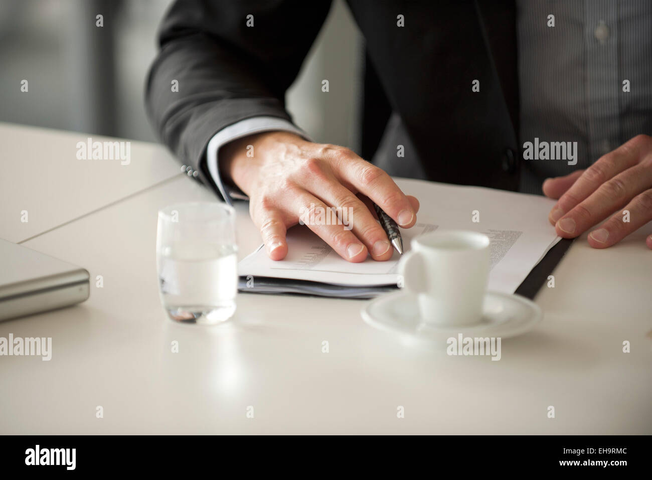 Businessman reviewing document, cropped Stock Photo - Alamy