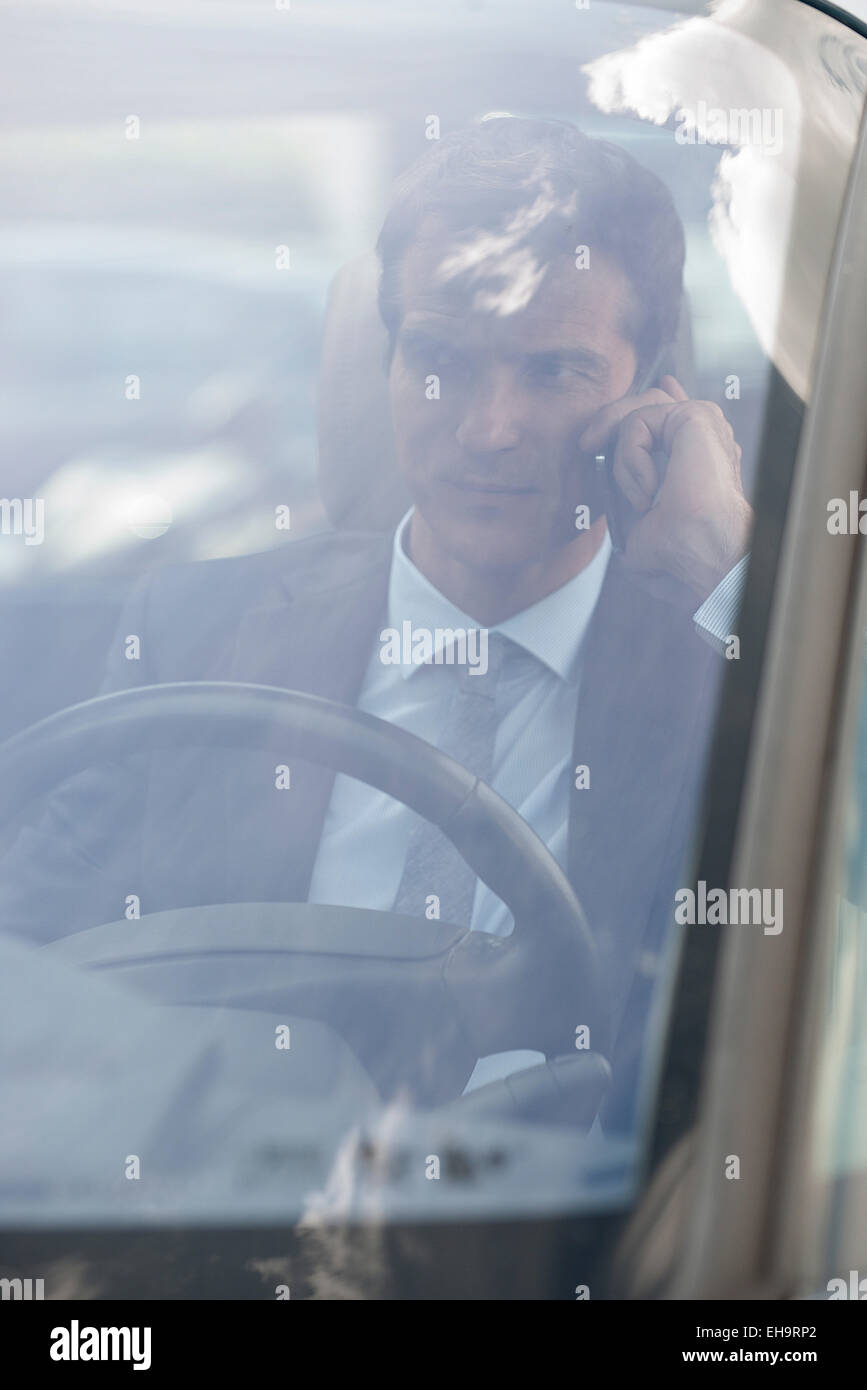 Mature businessman looking outside window hi-res stock photography and ...
