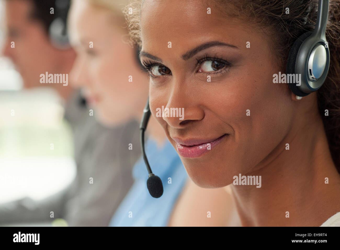 Woman working in call center, smiling confidently Stock Photo - Alamy