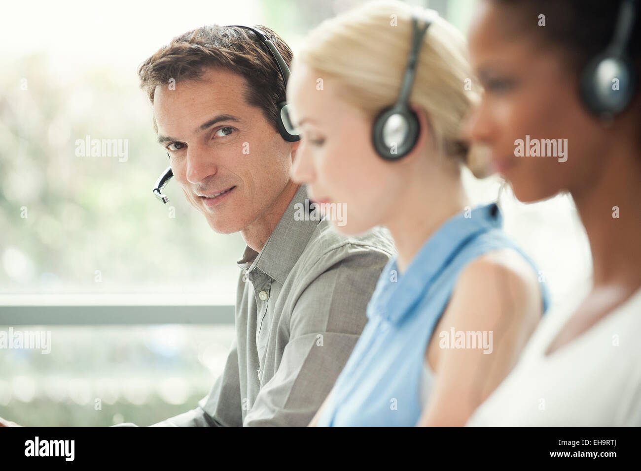 Professionals working in call center Stock Photo - Alamy