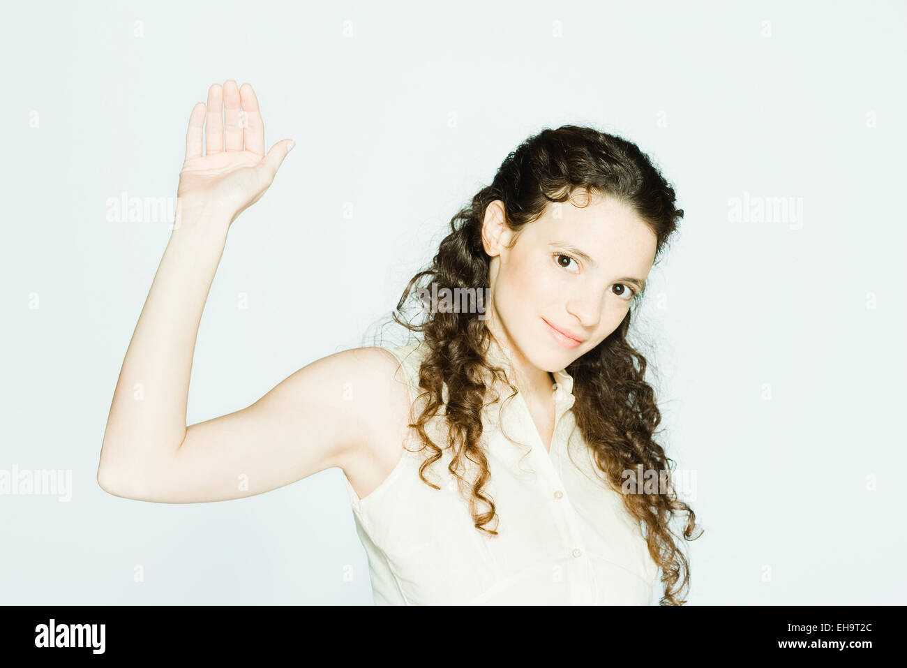 Young woman raising hand, portrait Stock Photo - Alamy