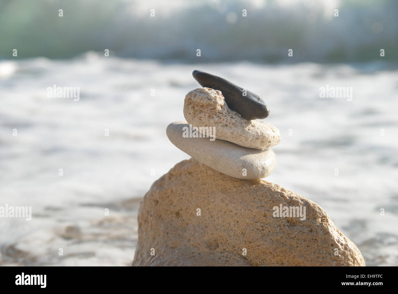 Zen stones with blue sky and sea background Stock Photo - Alamy