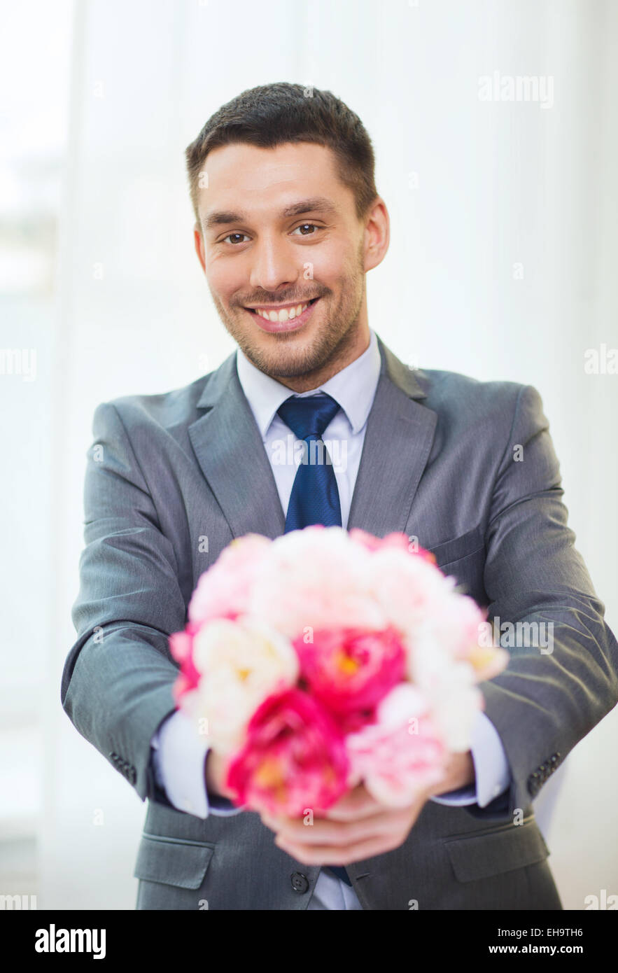 Handsome man giving bouquet flowers hi-res stock photography and images ...