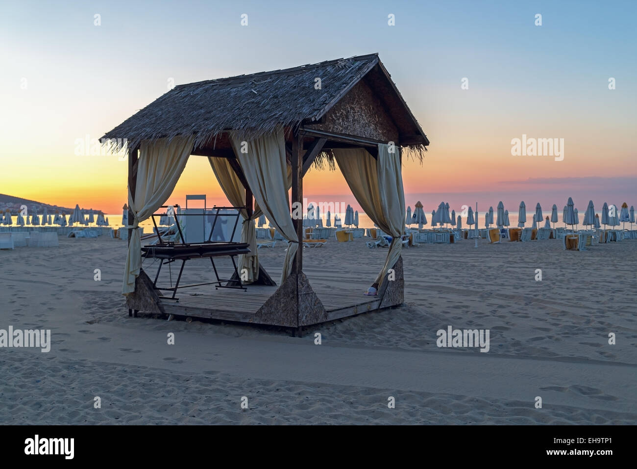 Massage canopy on a sandy beach in the early morning. Shallow depth of ...