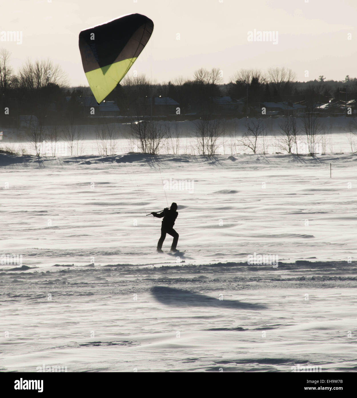 Parasailer glides over a frozen lake Stock Photo - Alamy