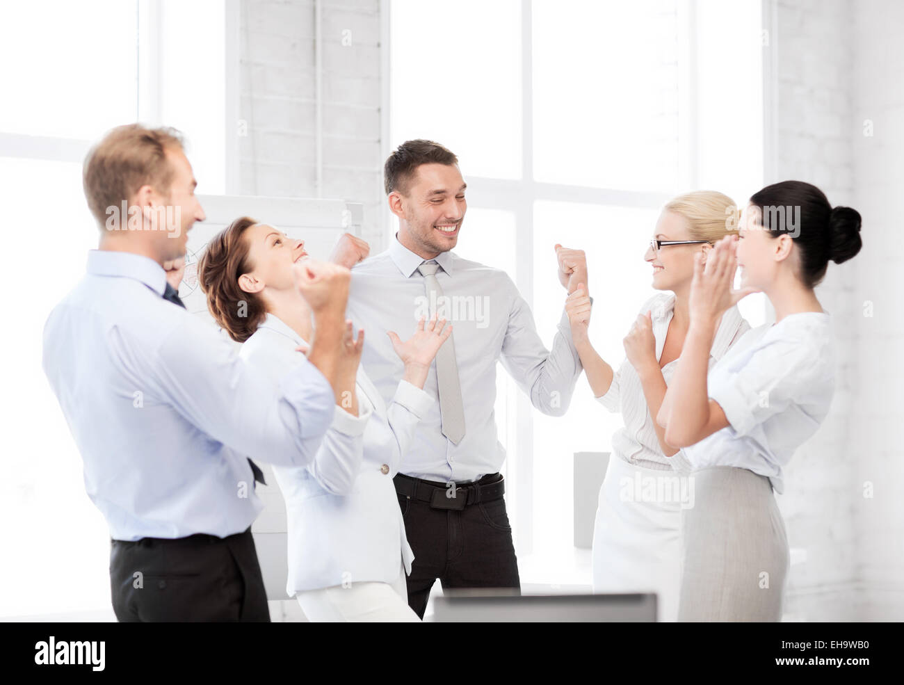business team celebrating victory in office Stock Photo - Alamy