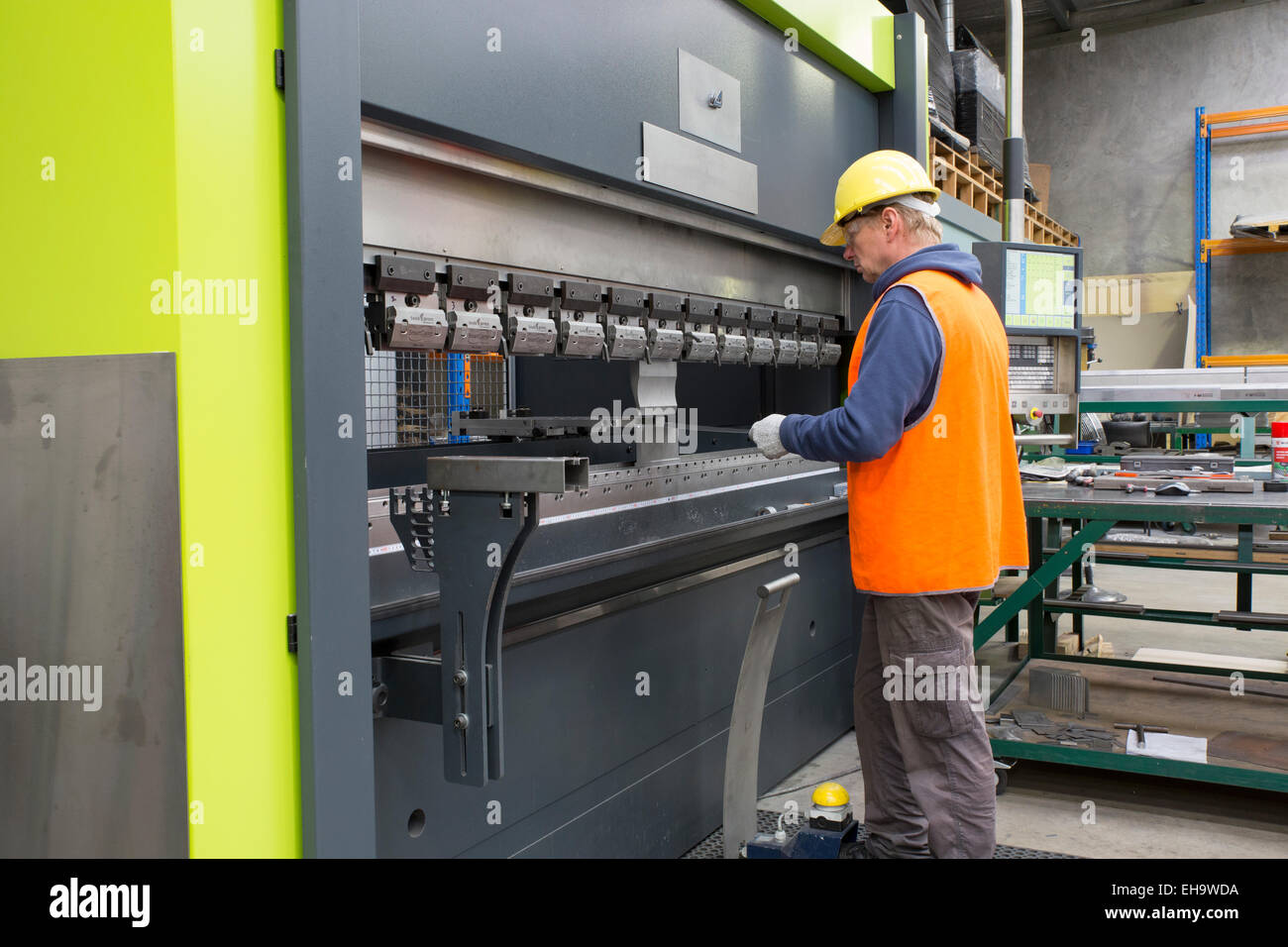 Metal Industry worker operates CNC Brake Press Machine Stock Photo - Alamy