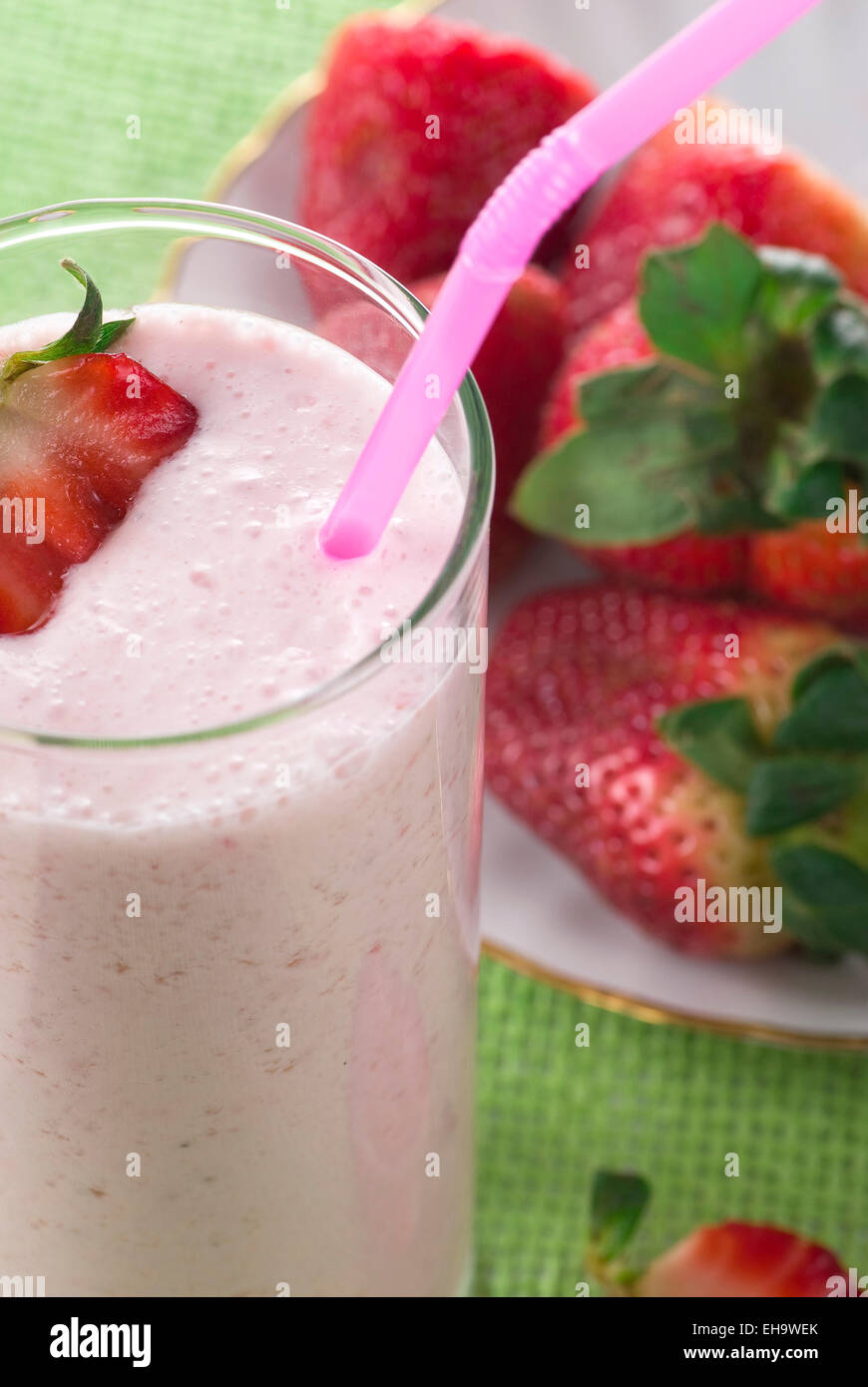 Strawberry milkshake with fresh strawberries and a straw Stock Photo ...