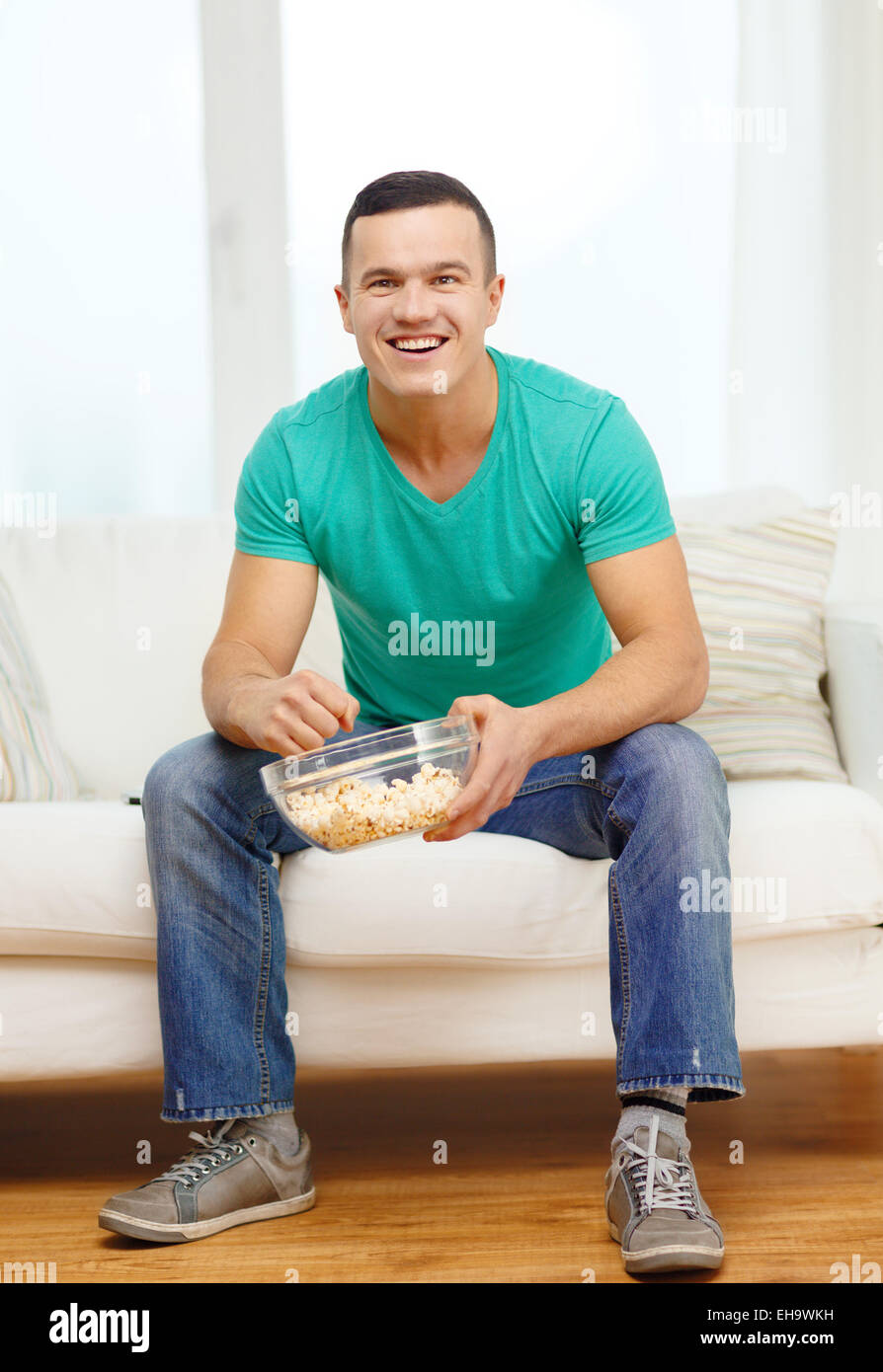 smiling man watching sports at home Stock Photo - Alamy