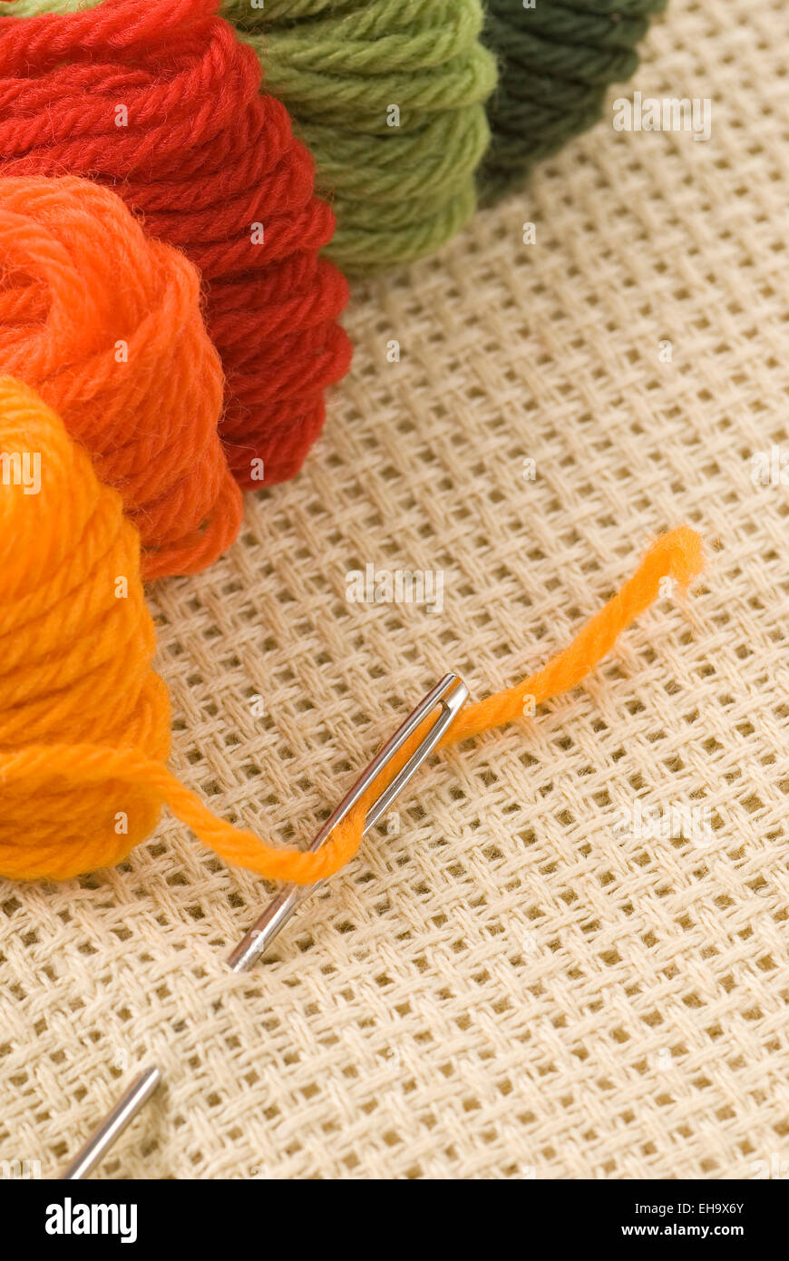 Embroidery yarn, needle and fabric Stock Photo - Alamy