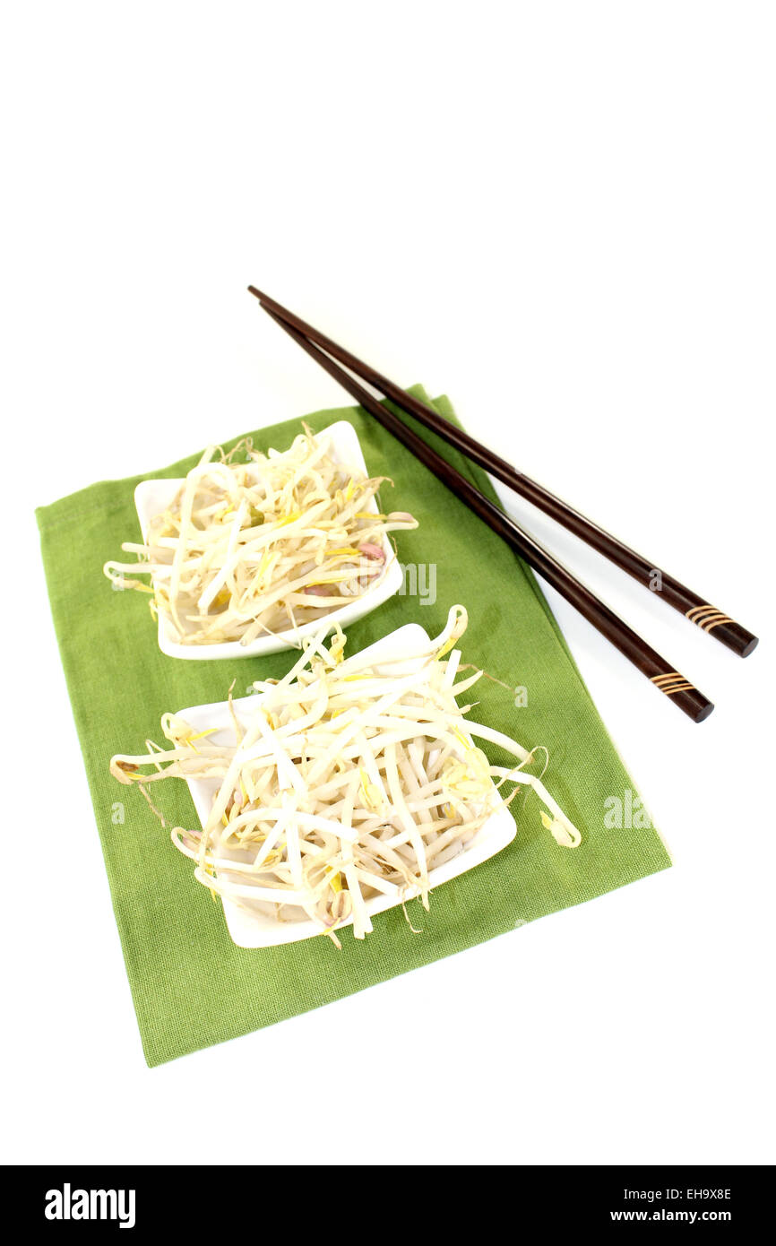 fresh bright mung bean sprouts with chopsticks on a light background ...