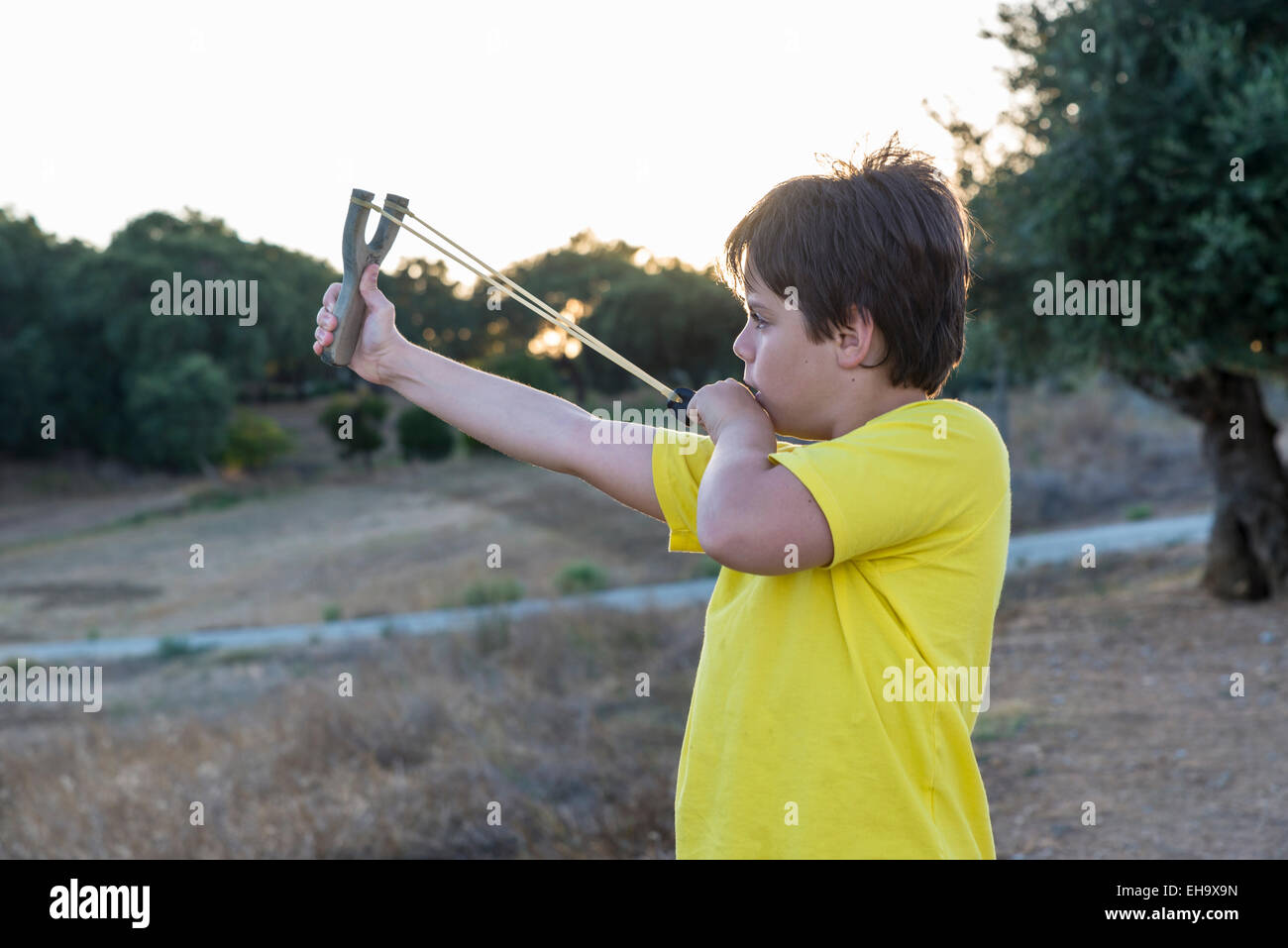 Ten-year-old is ready to fire his slingshot in a forest Stock Photo - Alamy