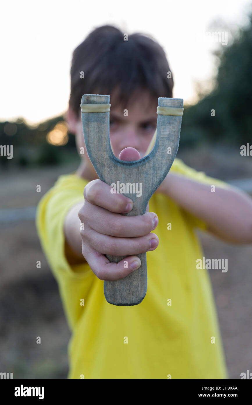 Ten-year-old is ready to fire his slingshot in a forest Stock Photo - Alamy