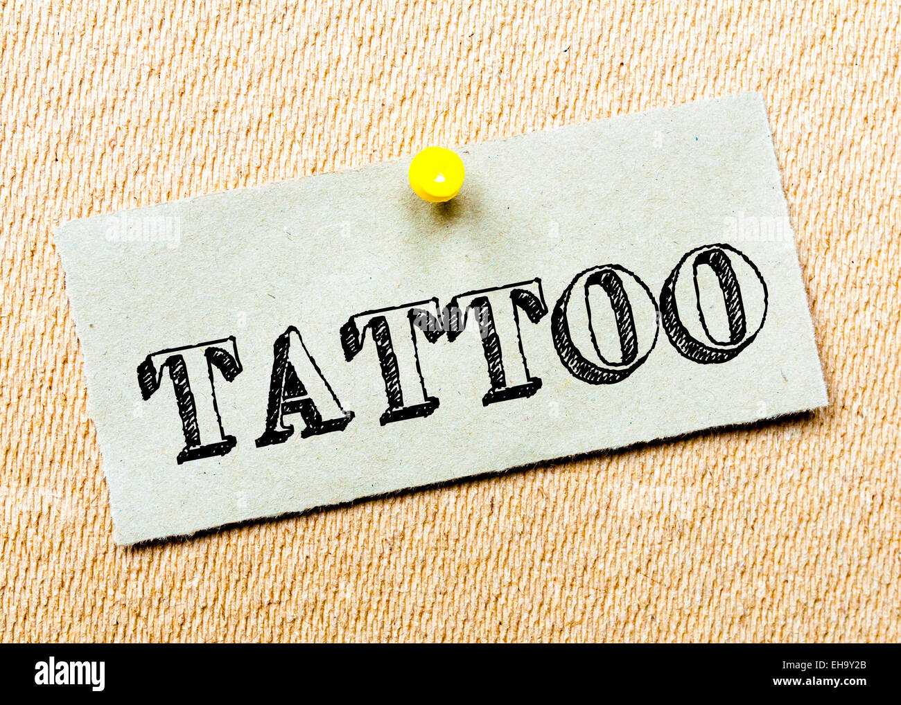 Recycled paper note pinned on cork board. Tattoo Message. Concept Image ...