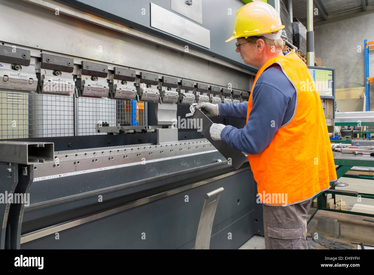 metal industry worker checks angle on folded sheet metal part Stock ...