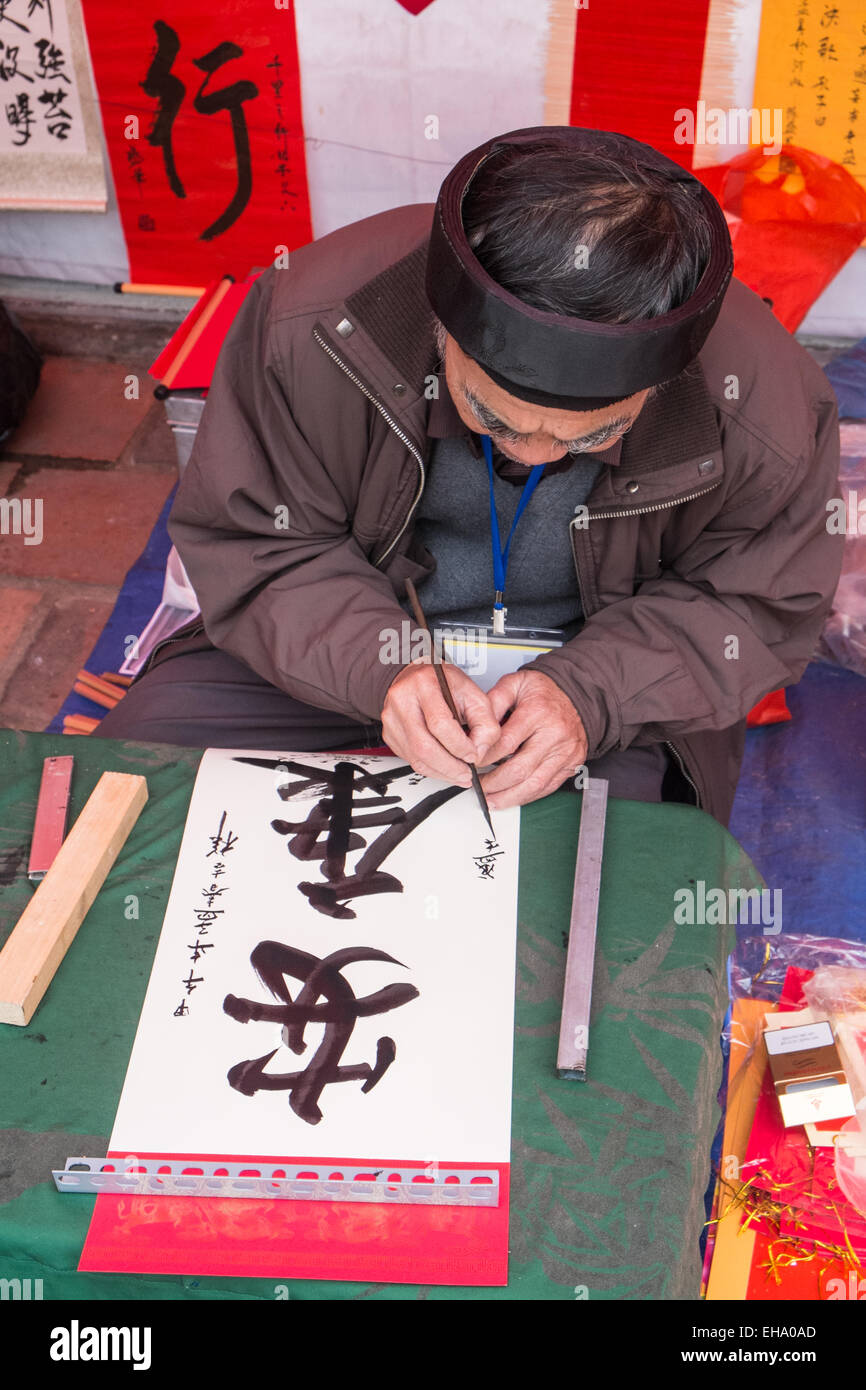 Artist paints,calligraphy Hanoi, Vietnam, during Tet, the Vietnamese ...
