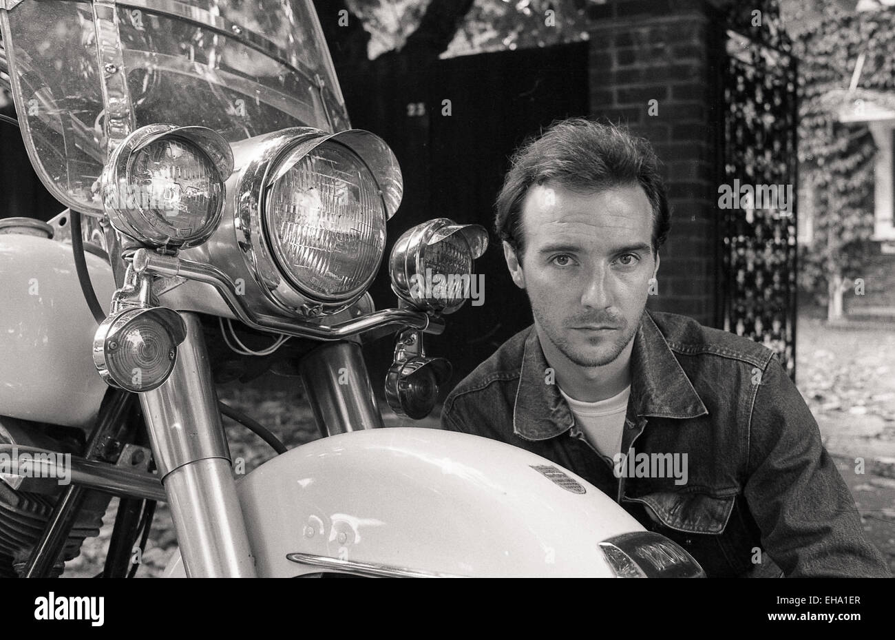 Midge Ure singer in Ultravox poses beside his Harley Davidson ...