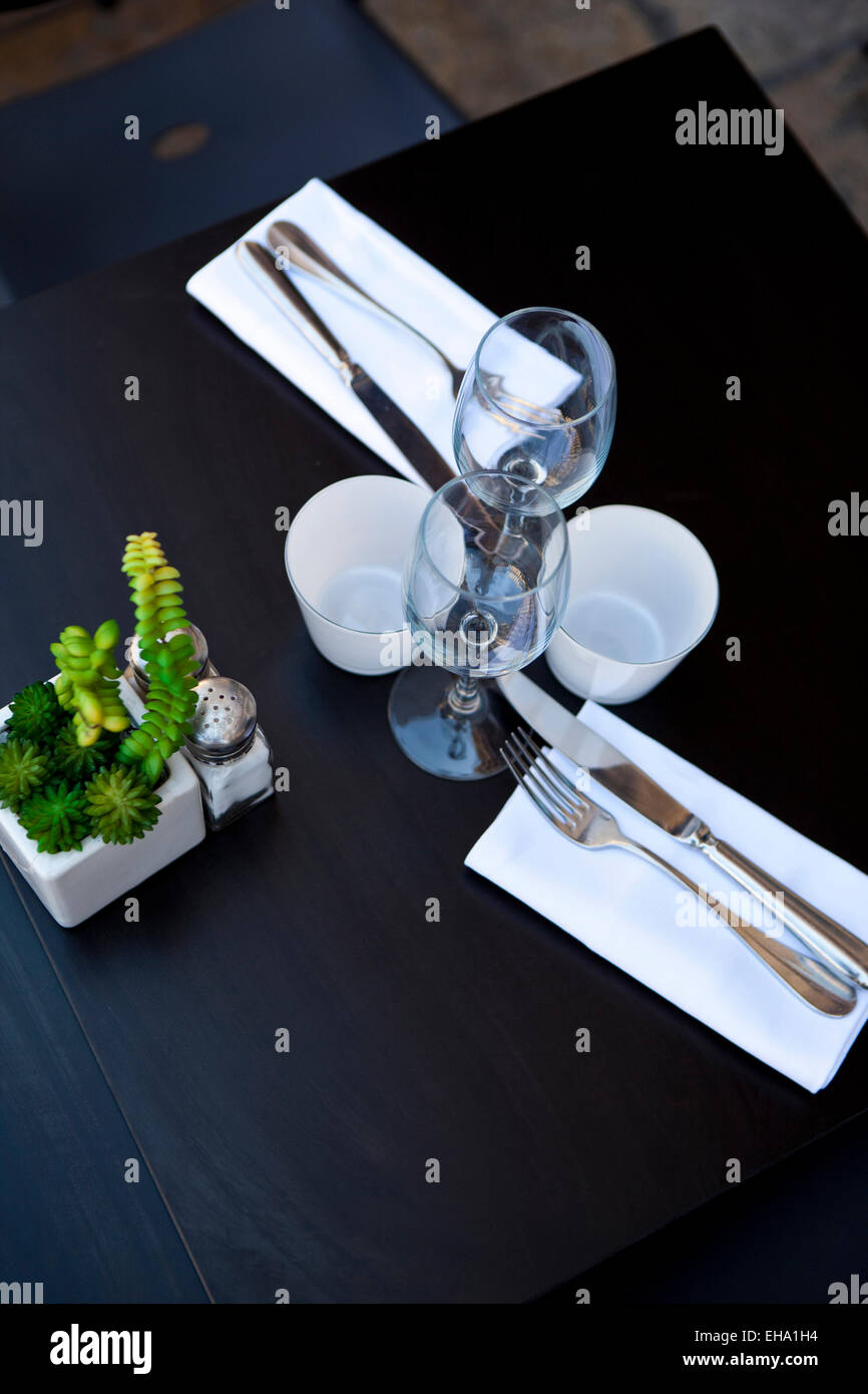 Table set and plants in a restaurant Stock Photo - Alamy