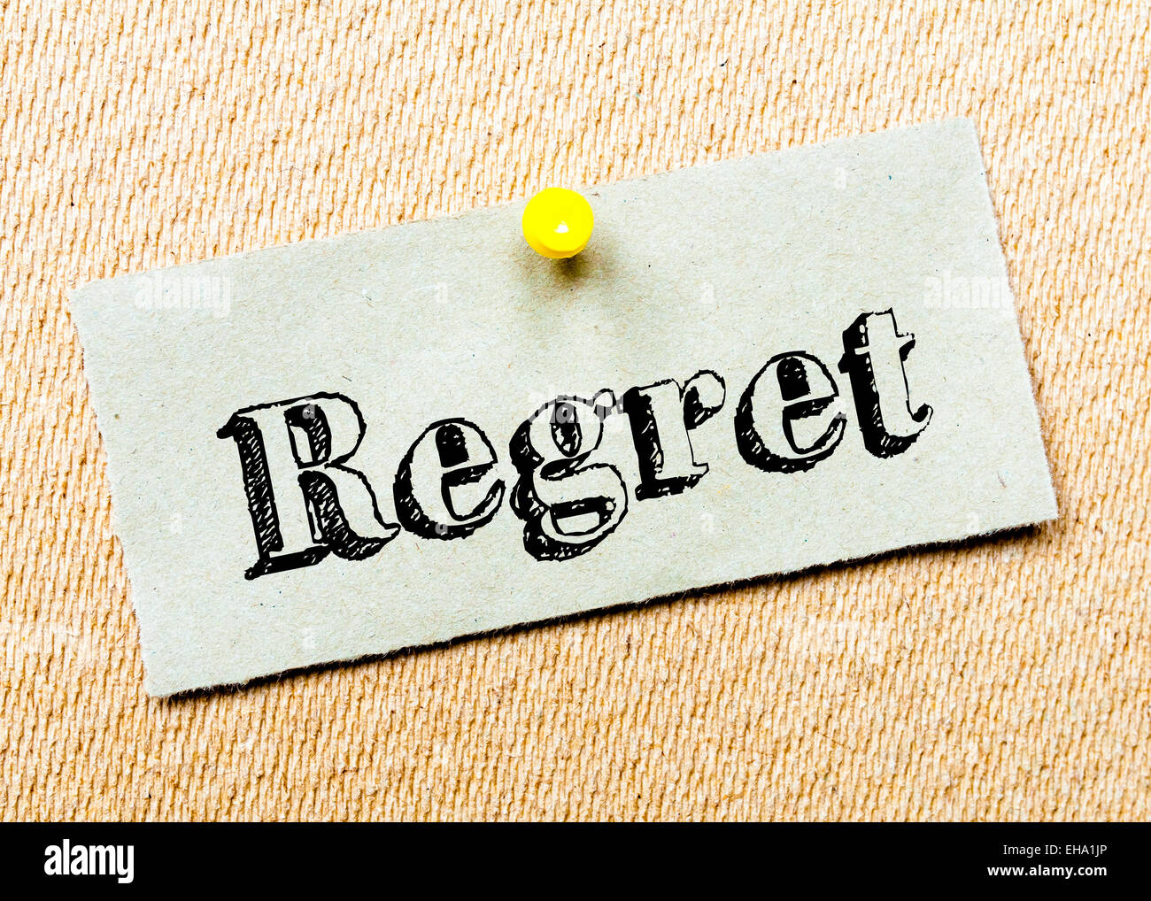 Recycled paper note pinned on cork board. Regret Message. Concept Image ...