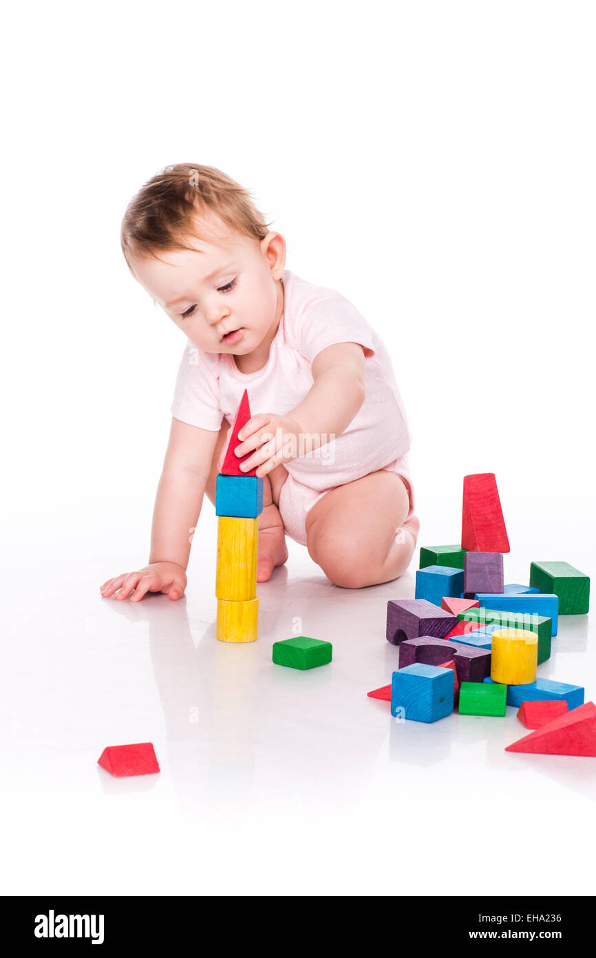 Beautiful baby building a castle with cubes isolated on white Stock ...
