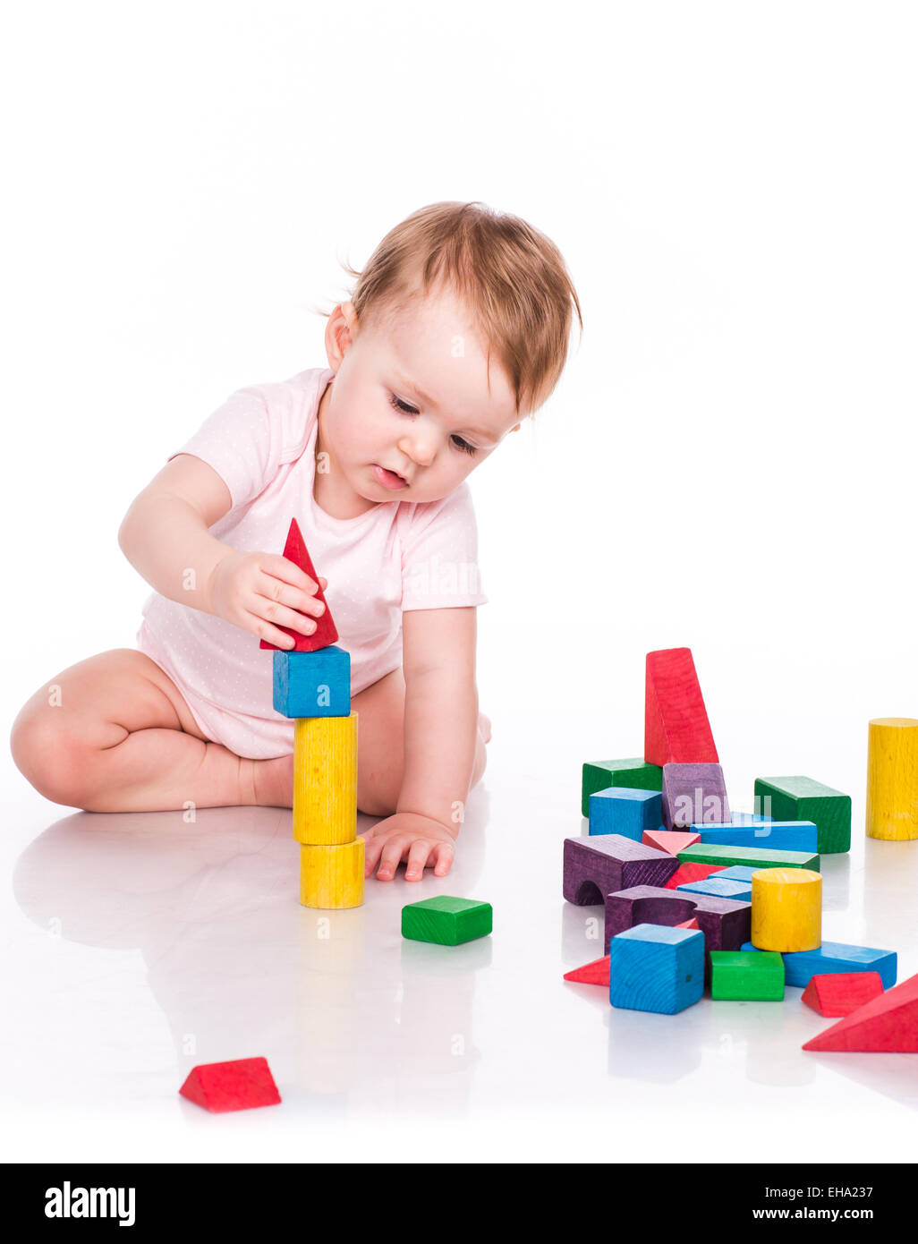 Beautiful baby building a castle with cubes isolated on white Stock ...