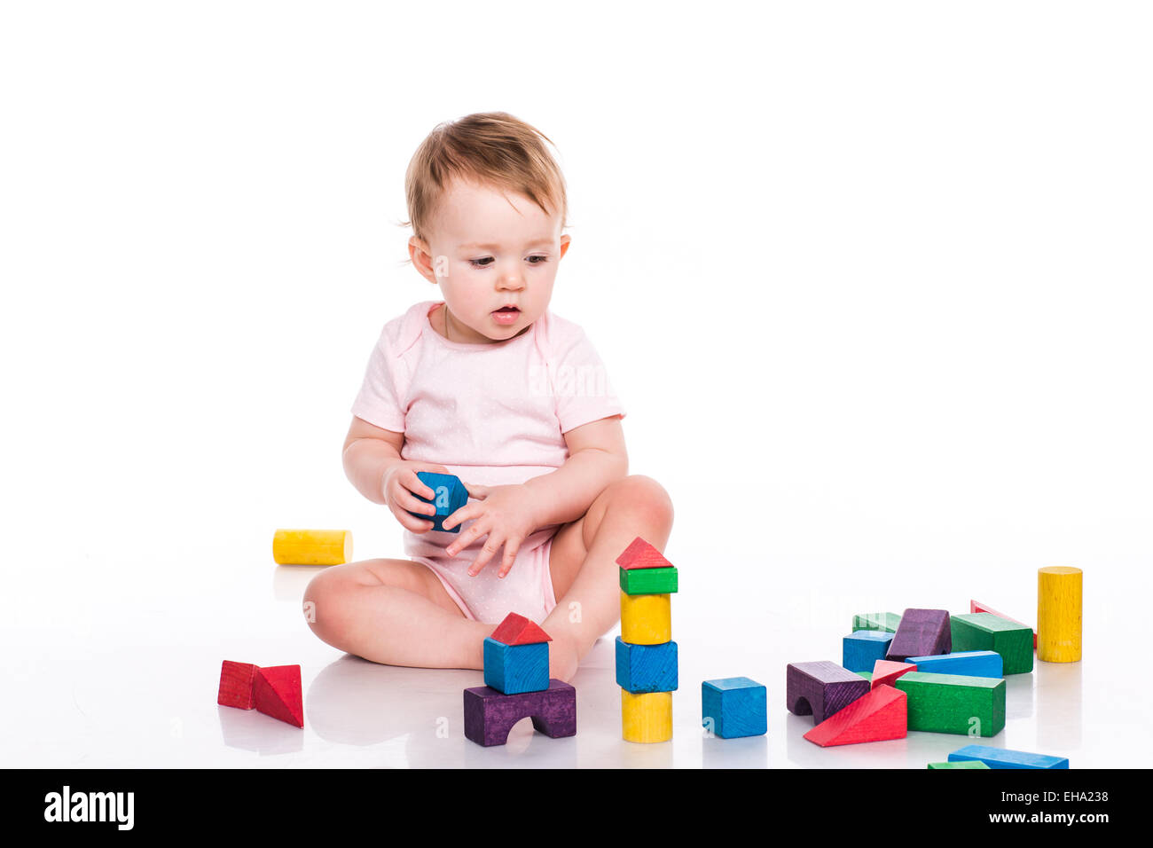 Beautiful baby building a castle with cubes isolated on white Stock ...