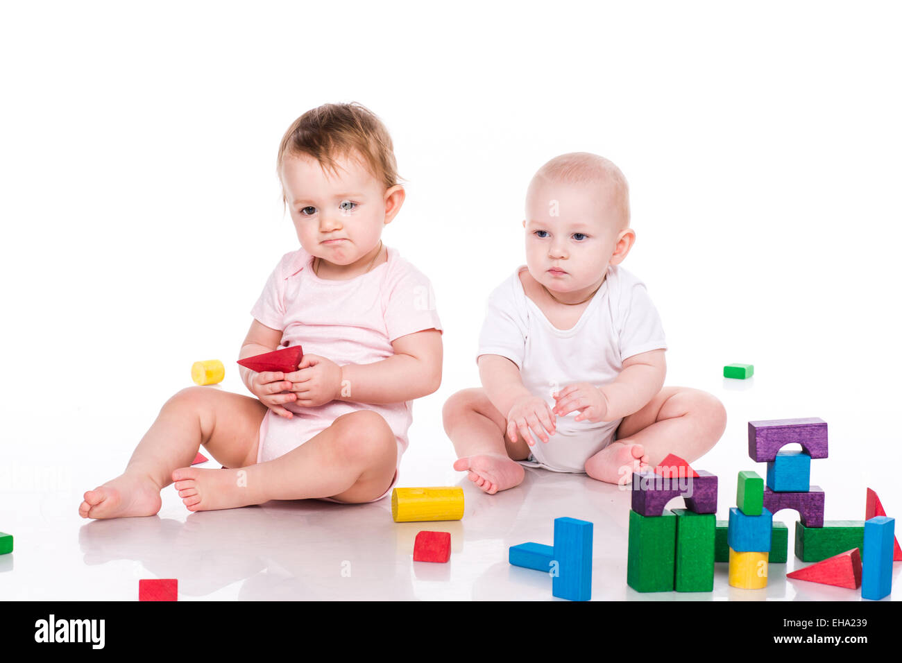 Beautiful babies building a castle with cubes isolated on white Stock ...