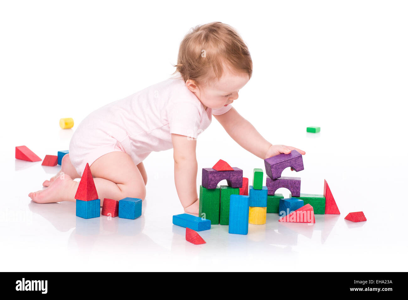 Beautiful baby building a castle with cubes isolated on white Stock ...