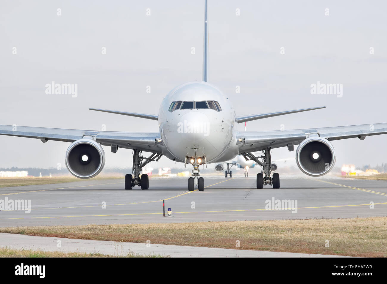 Passenger jet plane on the runway in the airport (front view Stock ...