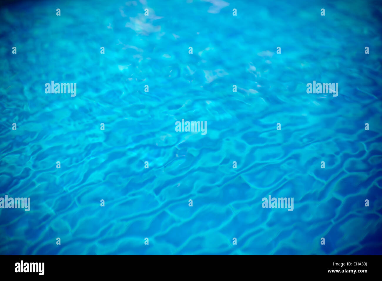 Clear transparent pool water defocused background. Sun reflections in ...